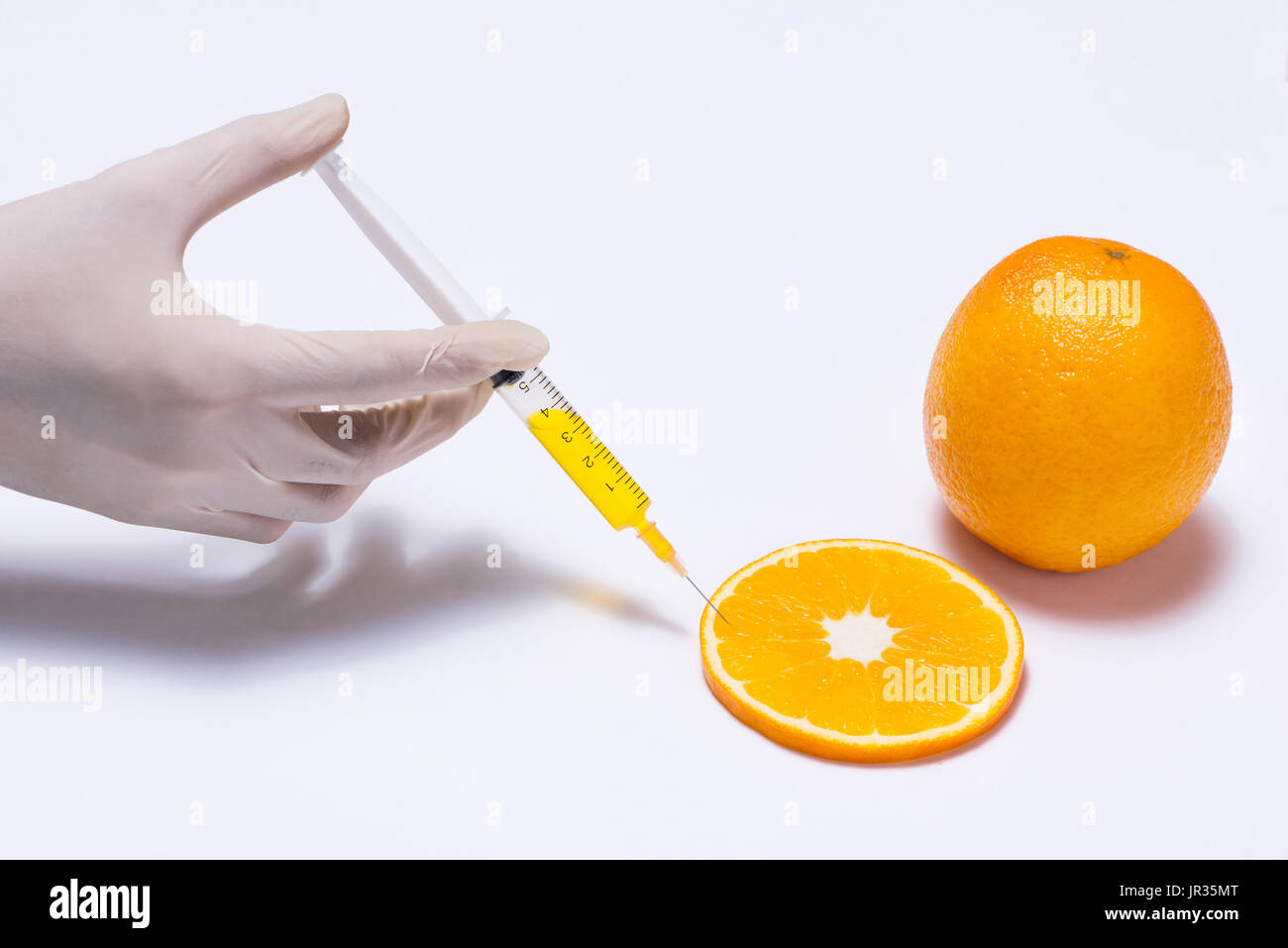 Science experiment with orange and syringe isolated on white Stock ...