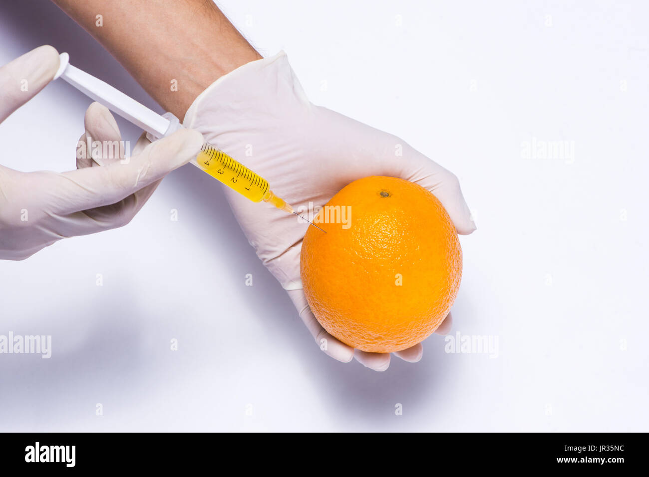 Science experiment with orange and syringe isolated on white Stock ...