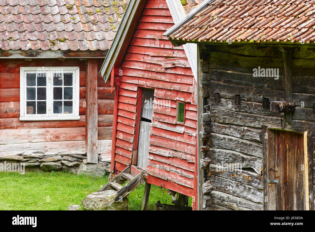 Traditional norwegian wooden red colored cabin houses facades. Otternes ...