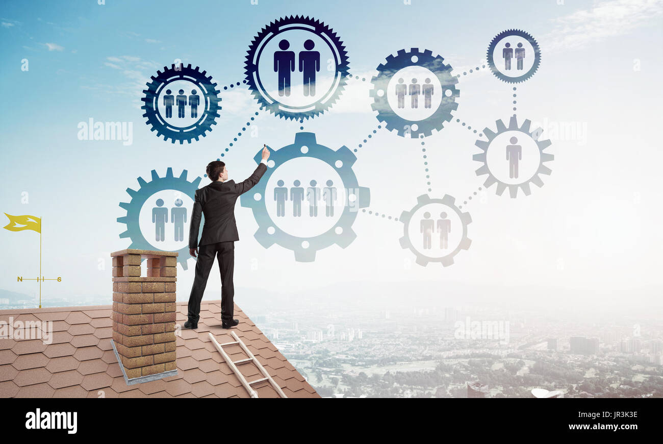 Businessman on house roof presenting teamwork and connection concept ...