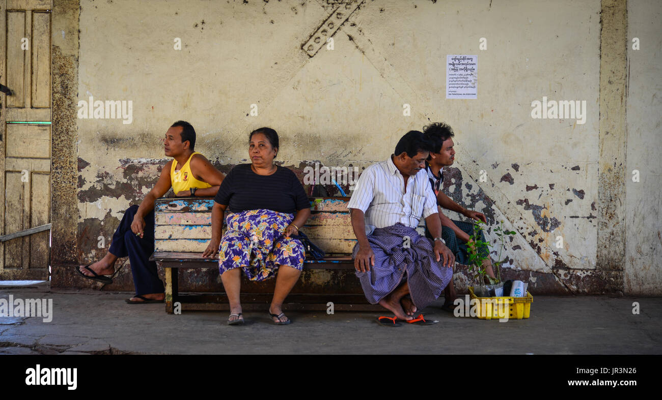 Yangon, Myanmar - Feb 13, 2017. Burmese people sitting at railway ...