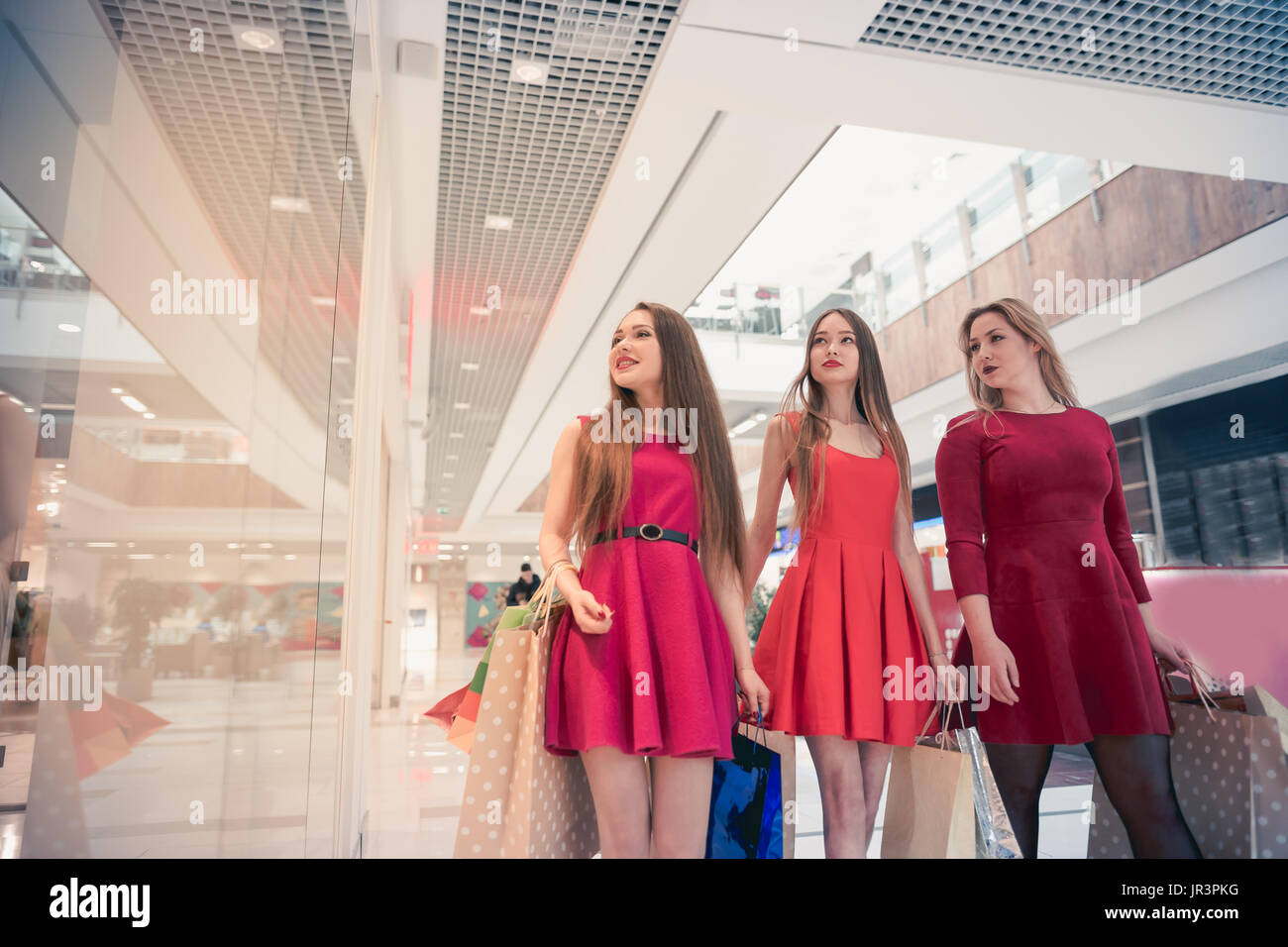 Beautiful girls with shopping bags walking at the mall Stock Photo - Alamy