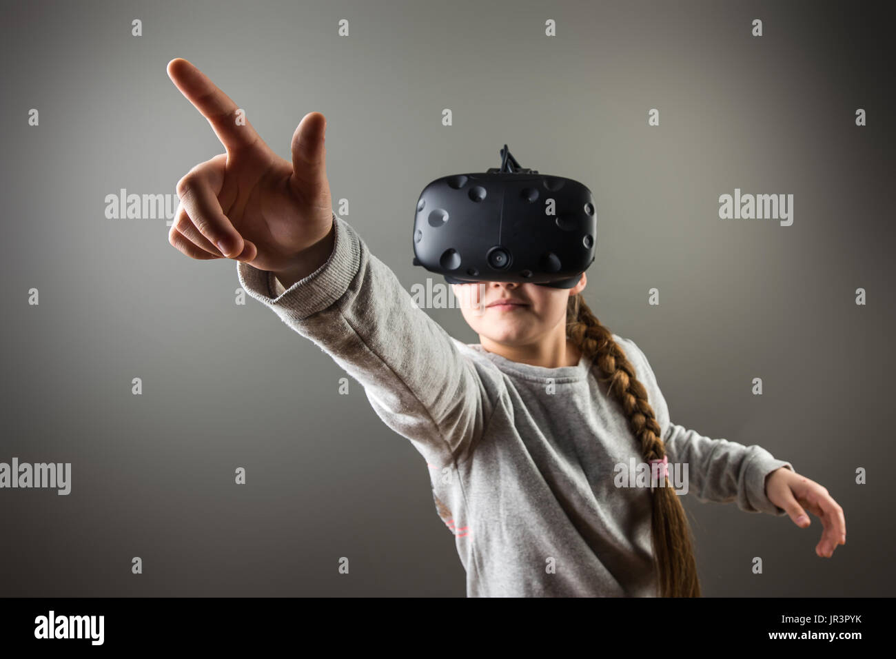 surprised little girl using a virtual reality headset Stock Photo - Alamy