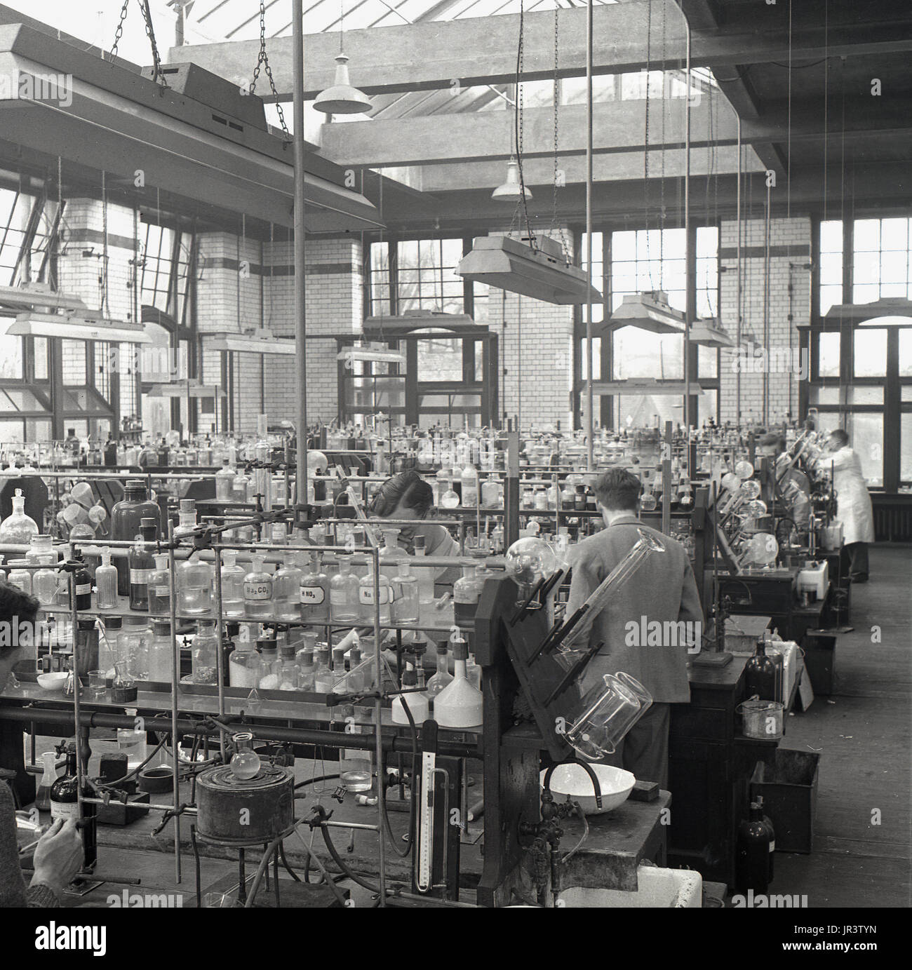 1951, historical, female mathematician in white coat at a workbench ...