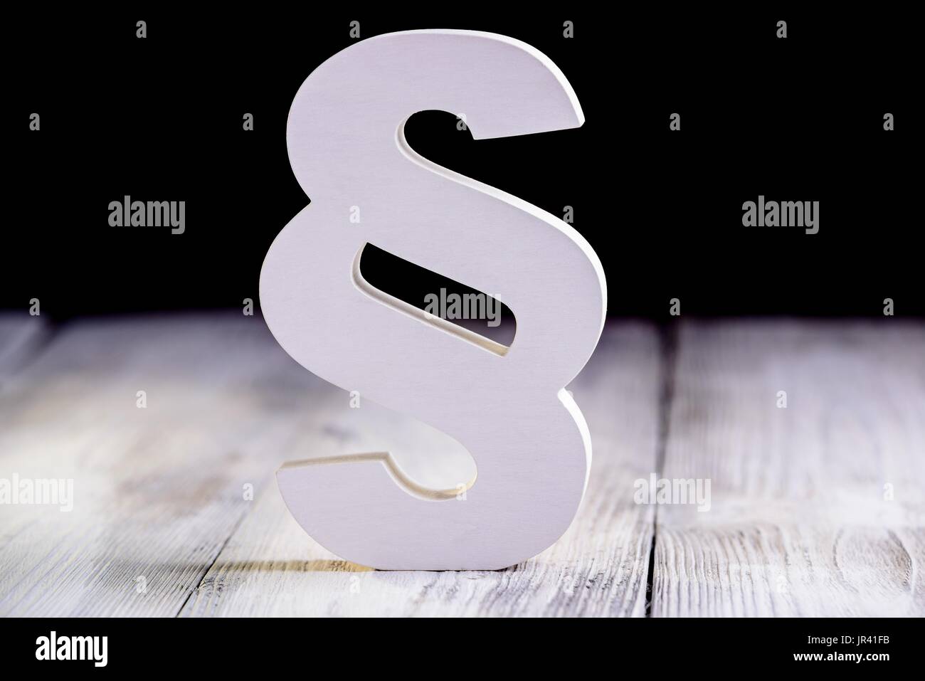 White wooden paragraph - law symbol on black background. Law concept ...