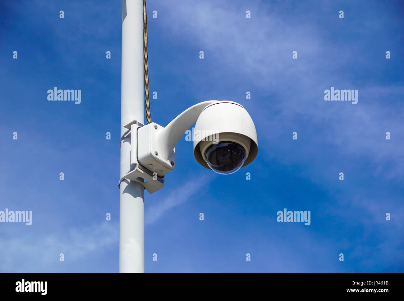 High tech overhead security camera with a gradient blue sky Stock Photo ...