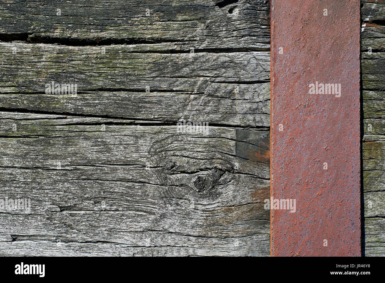 Antique wooden beam texture background with a rusty metallic plate ...