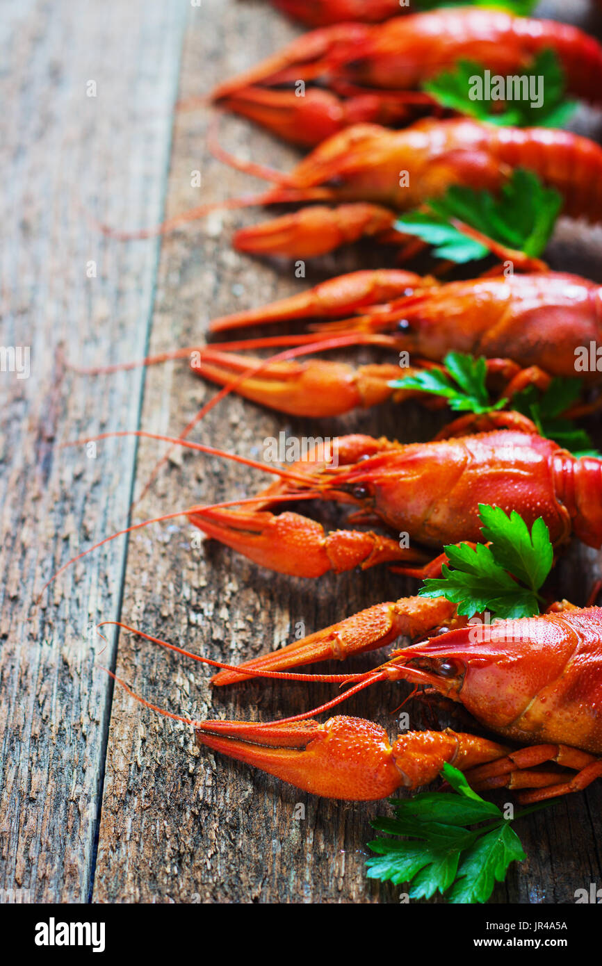 Boiled crayfish on a wooden old background Stock Photo - Alamy