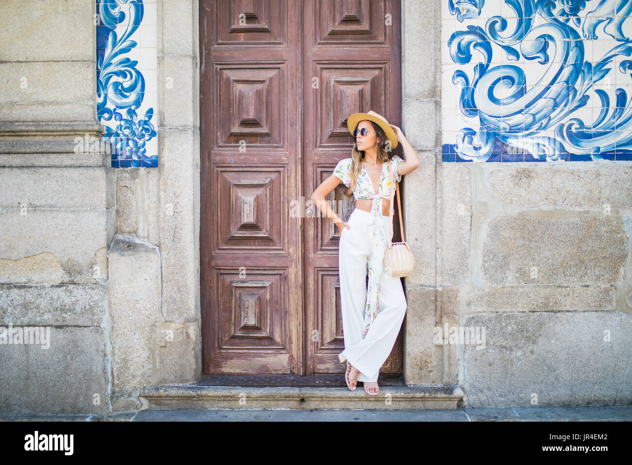 Portrait of young woman, model of fashion wearing dress and sun hat ...
