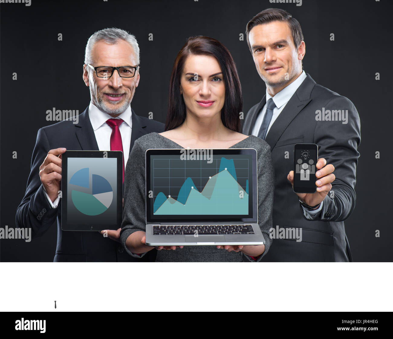 Business people holding digital devices Stock Photo - Alamy