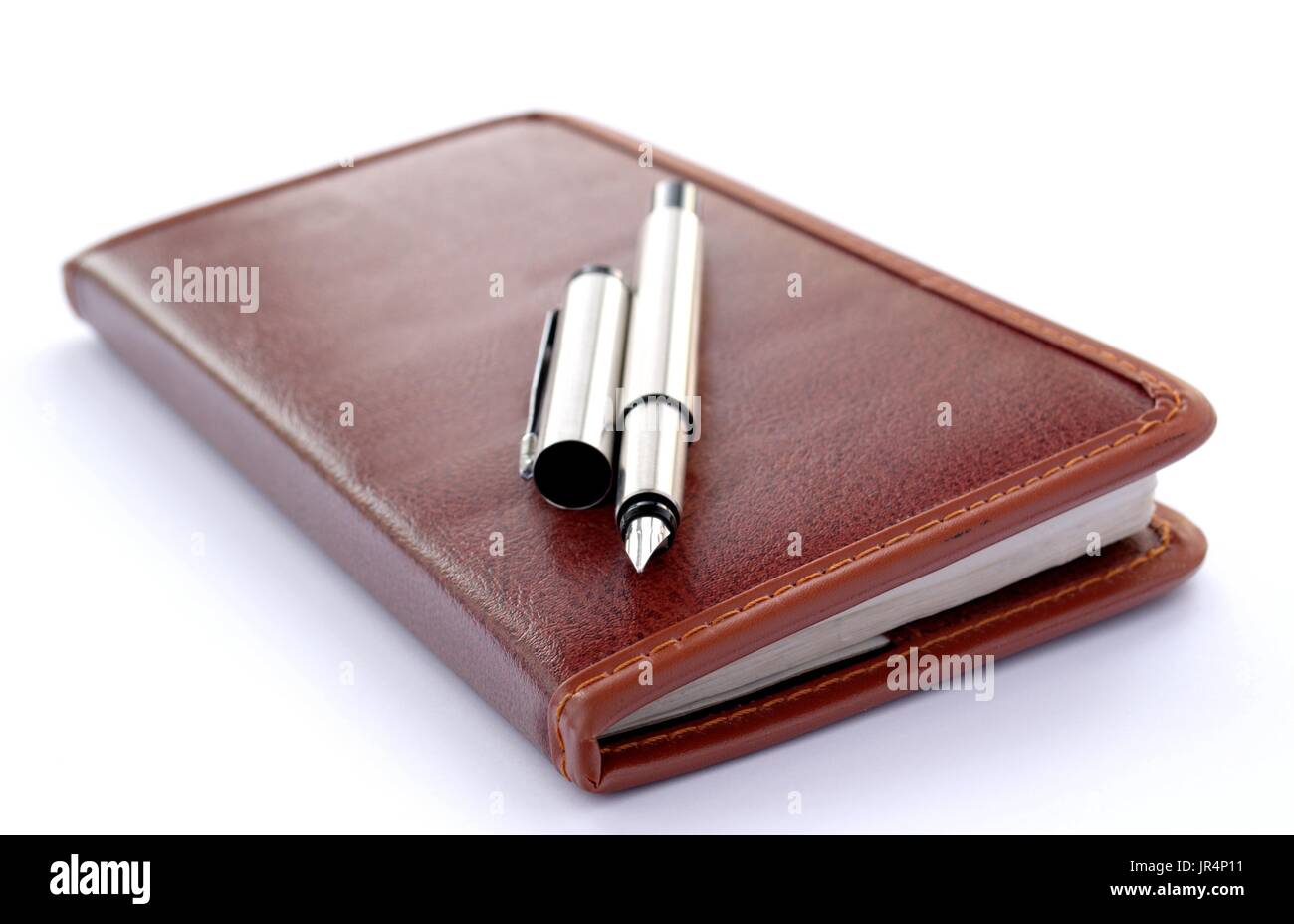 check book and a fountain pen on a white background Stock Photo - Alamy