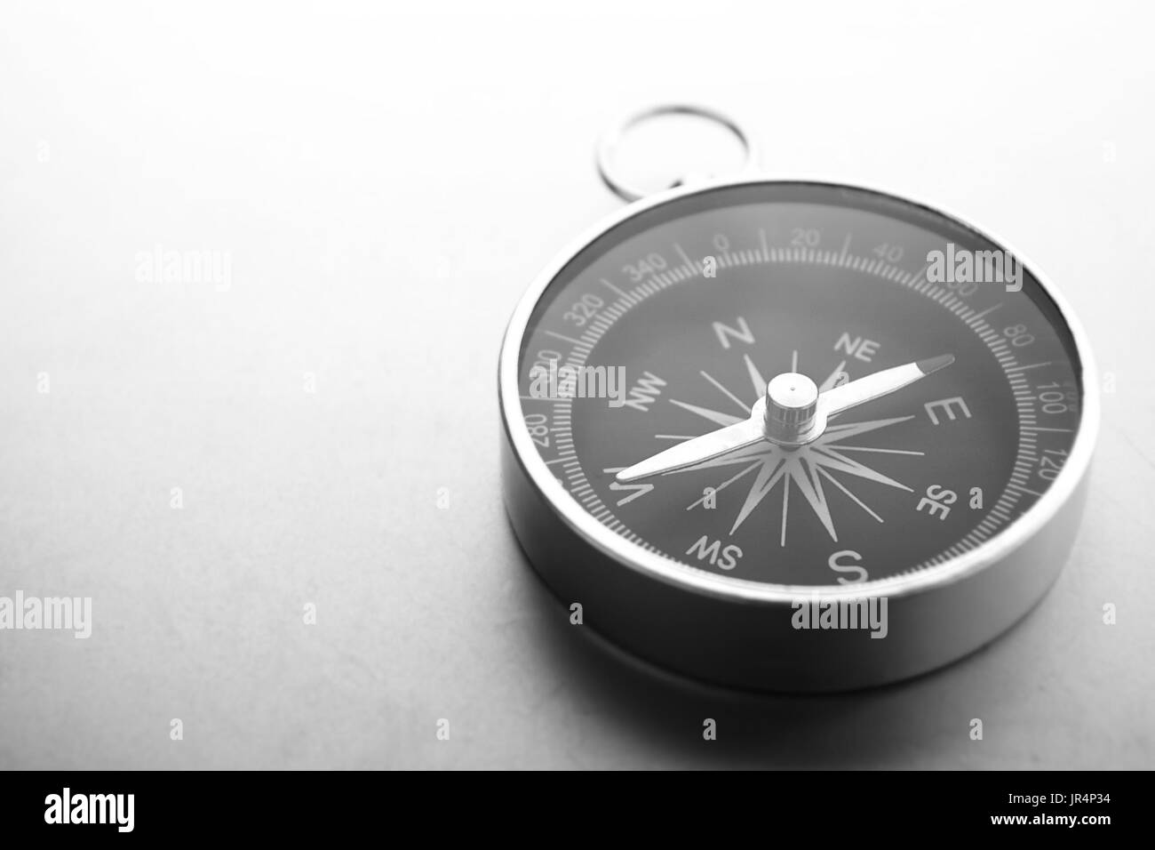 Compass on a gray gradient background, place for text Stock Photo - Alamy