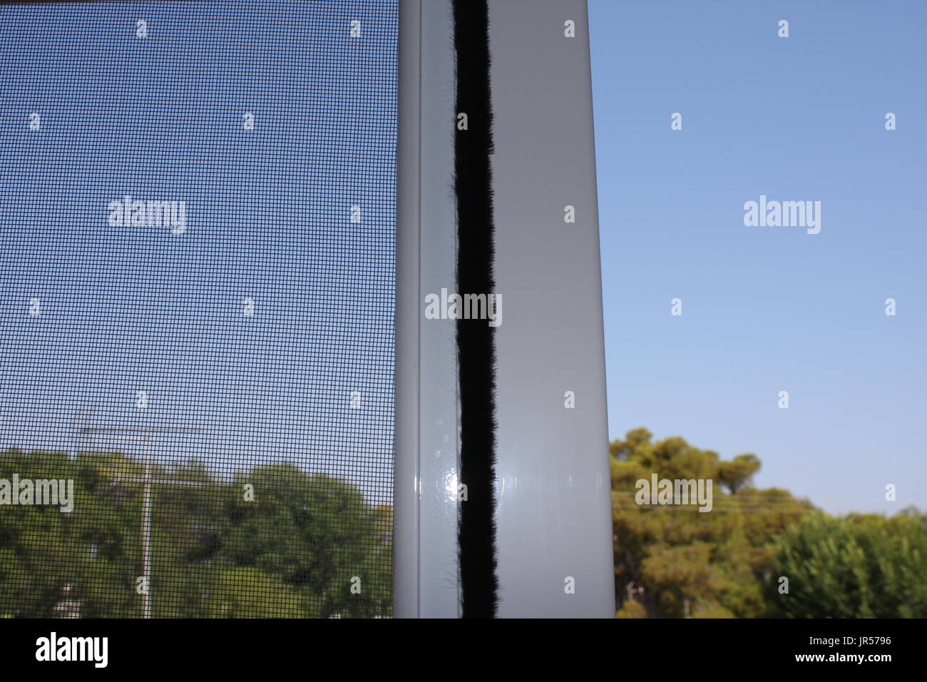 Installing mosquito nets for plastic windows Stock Photo - Alamy