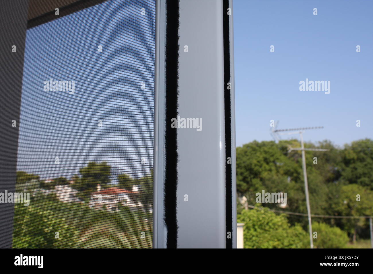 Installing mosquito nets for plastic windows Stock Photo - Alamy