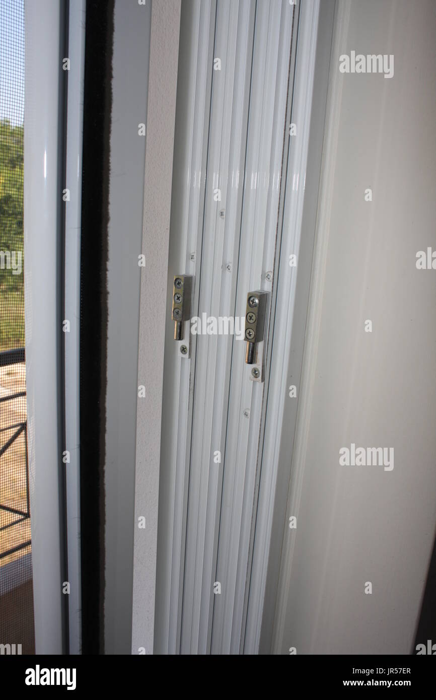 Installing mosquito nets for plastic windows Stock Photo - Alamy