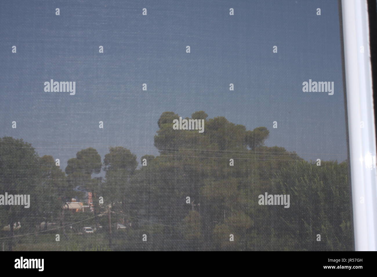 Installing mosquito nets for plastic windows Stock Photo - Alamy