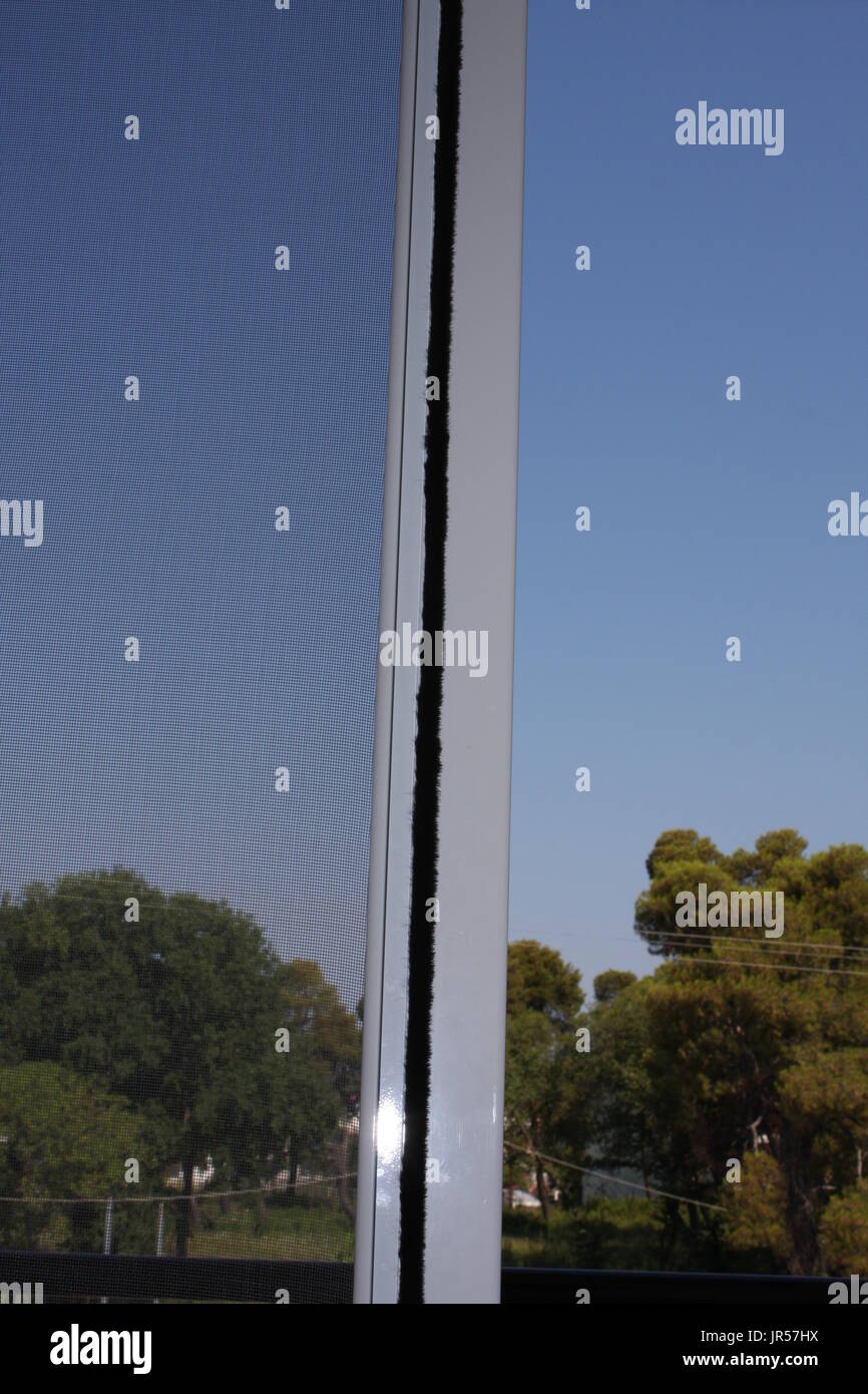 Installing mosquito nets for plastic windows Stock Photo - Alamy