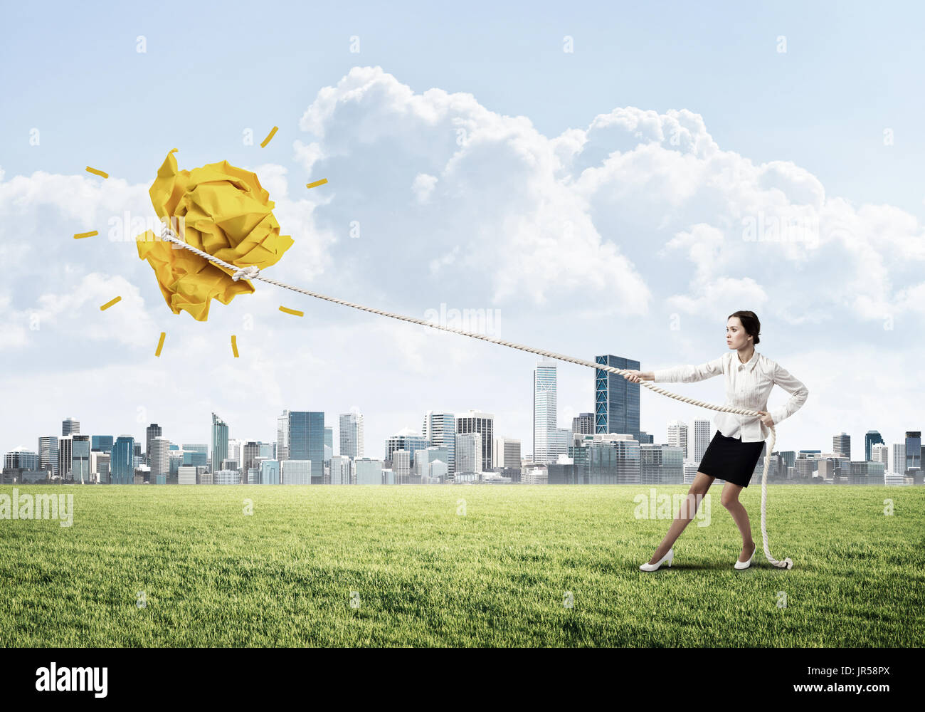 Businesswoman pulling paper ball with rope and making it raise up Stock ...