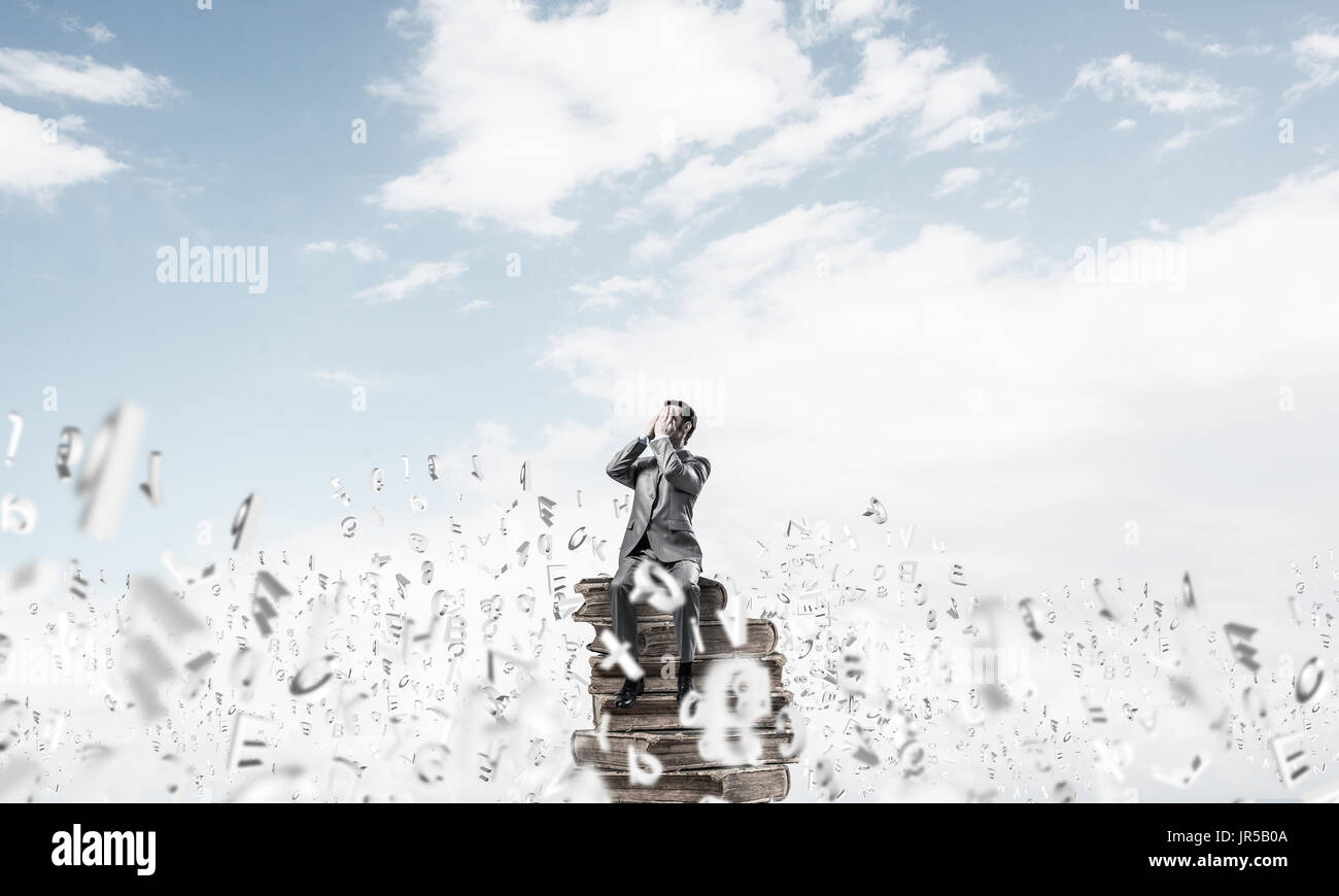 Young man floating in sky and do not want to see anything Stock Photo ...