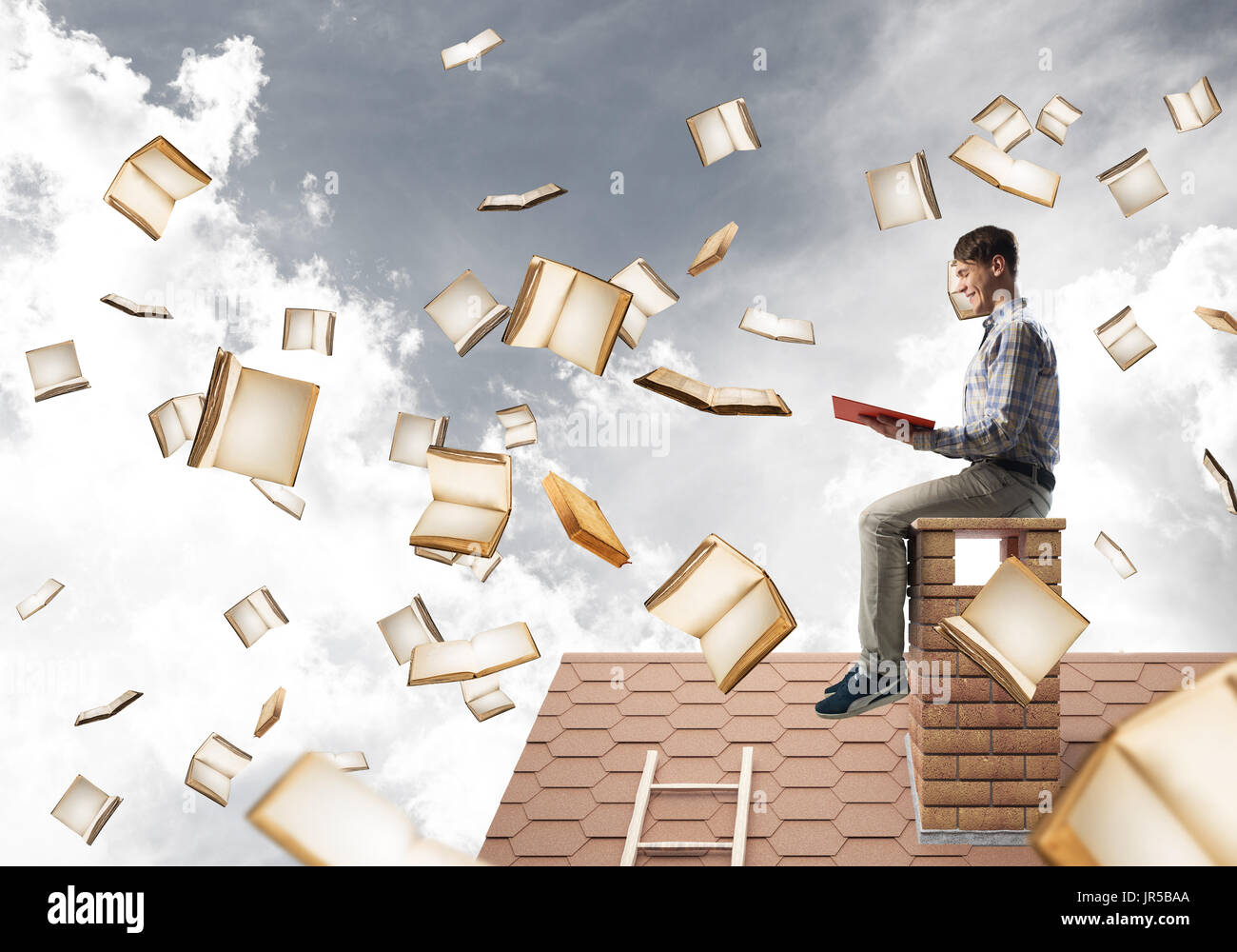 Man reading book and many of them flying in air Stock Photo - Alamy