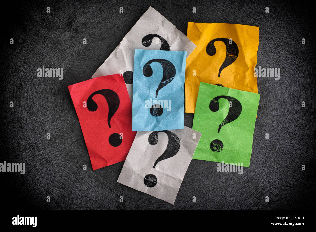Crumpled colorful paper notes with question marks. Close up Stock Photo ...