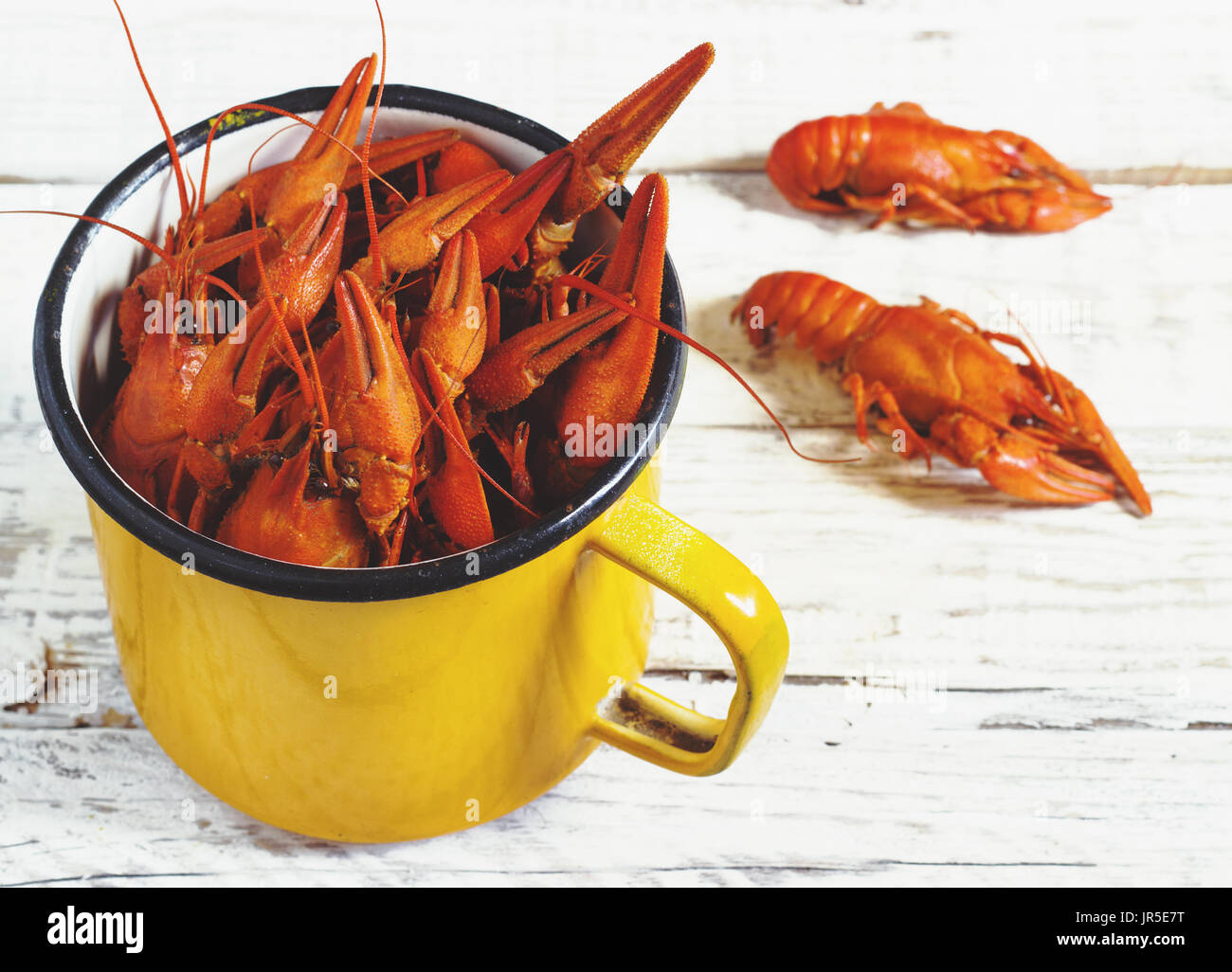 crawfish on wooden white background in metal mug Stock Photo - Alamy