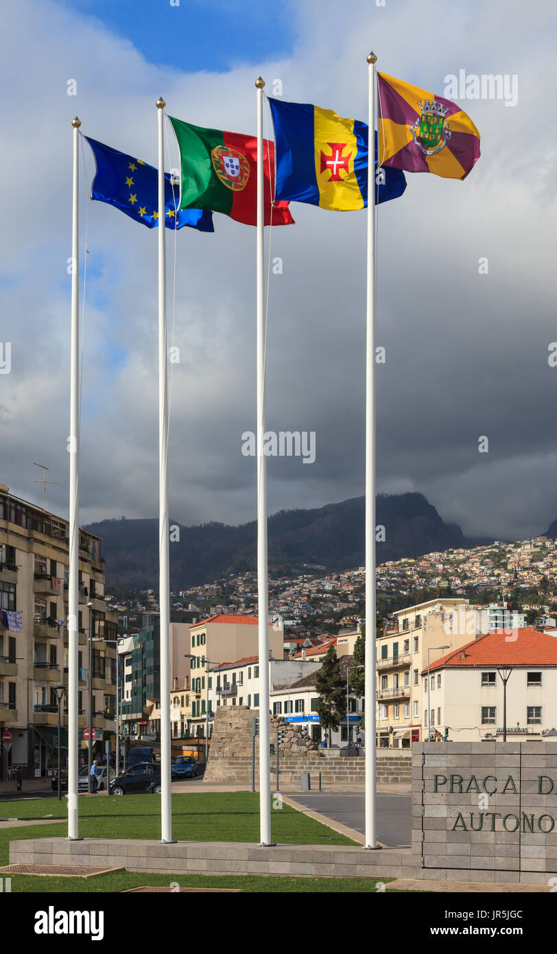 A collection of flags on the Funchal waterfront. The flags include ...