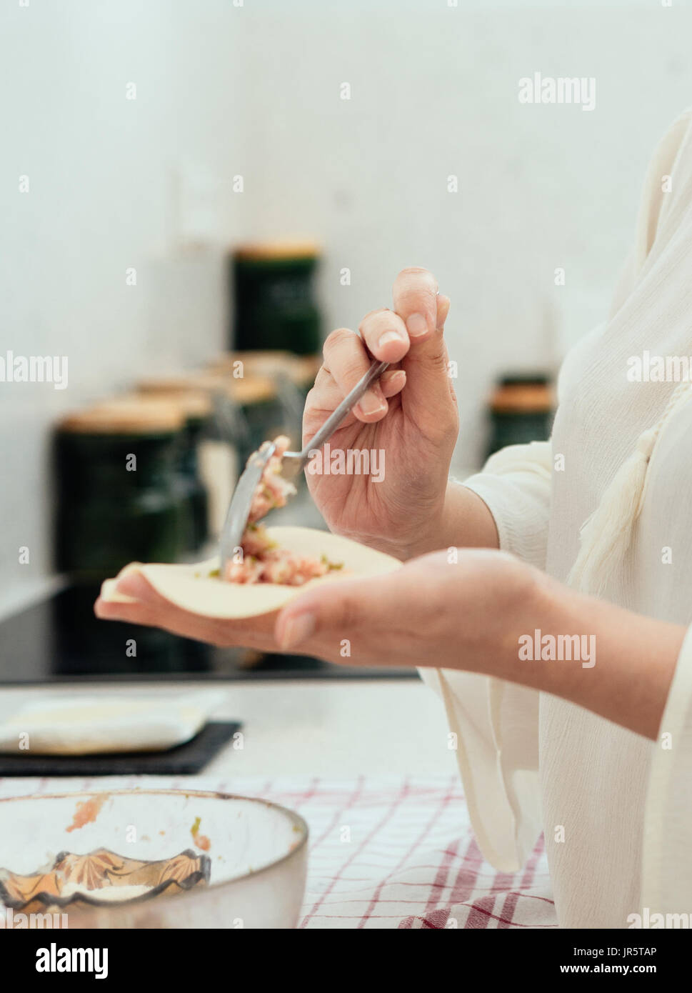 Woman preparing a Dumpling with a Spoon Stock Photo - Alamy