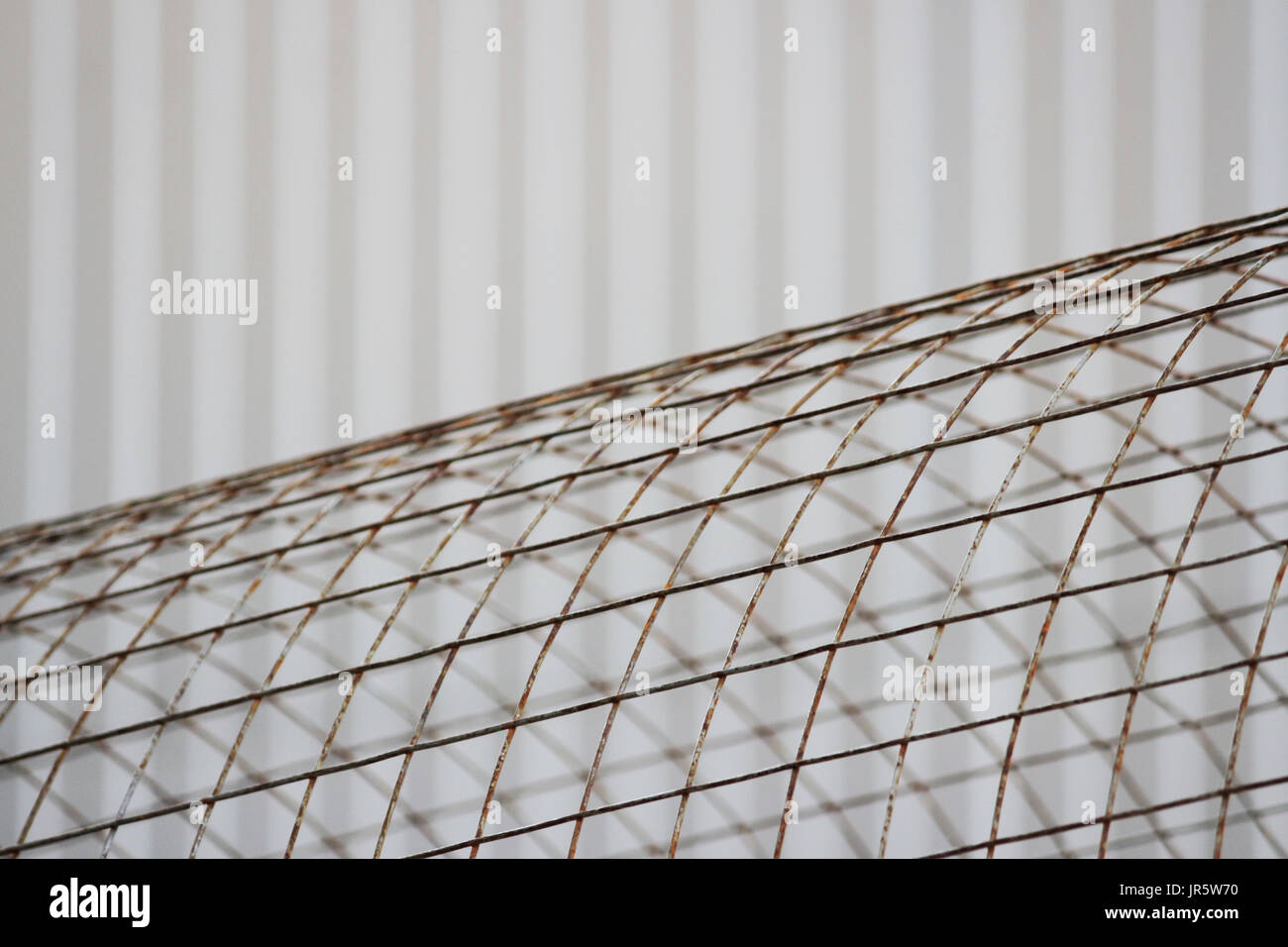 The bent sheet of metal iron reinforcement against the background of ...