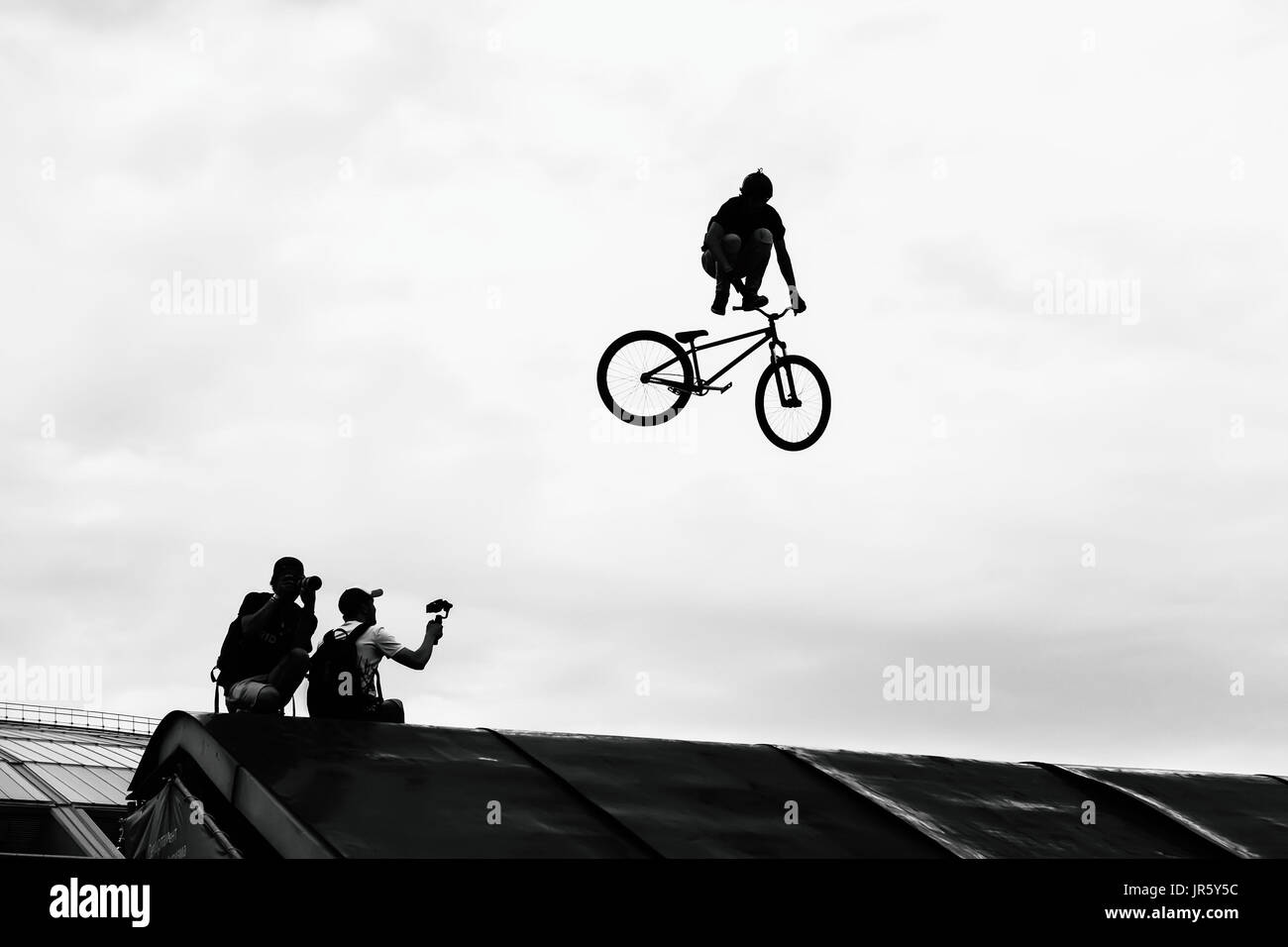Extrem Sport. BMX bike jumping in the sky on high speed, black and ...
