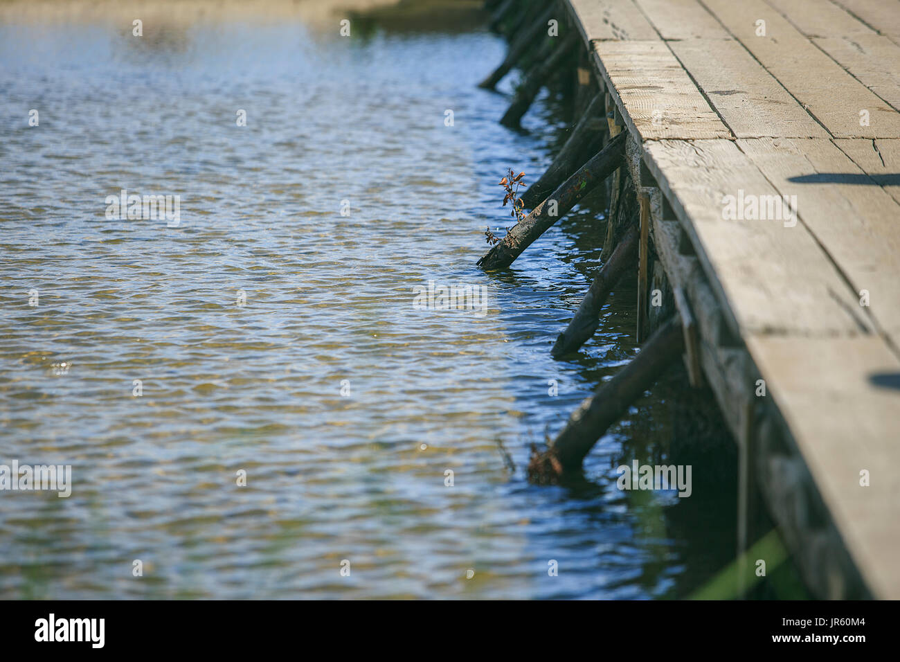 wooden foot bridge on a lake Stock Photo - Alamy