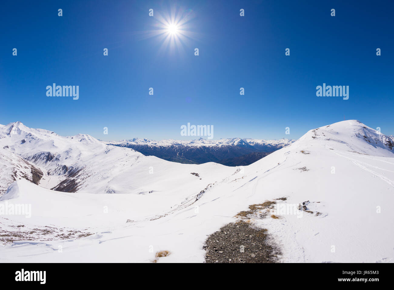 Wide angle view of a ski resort in the distance with elegant mountain ...
