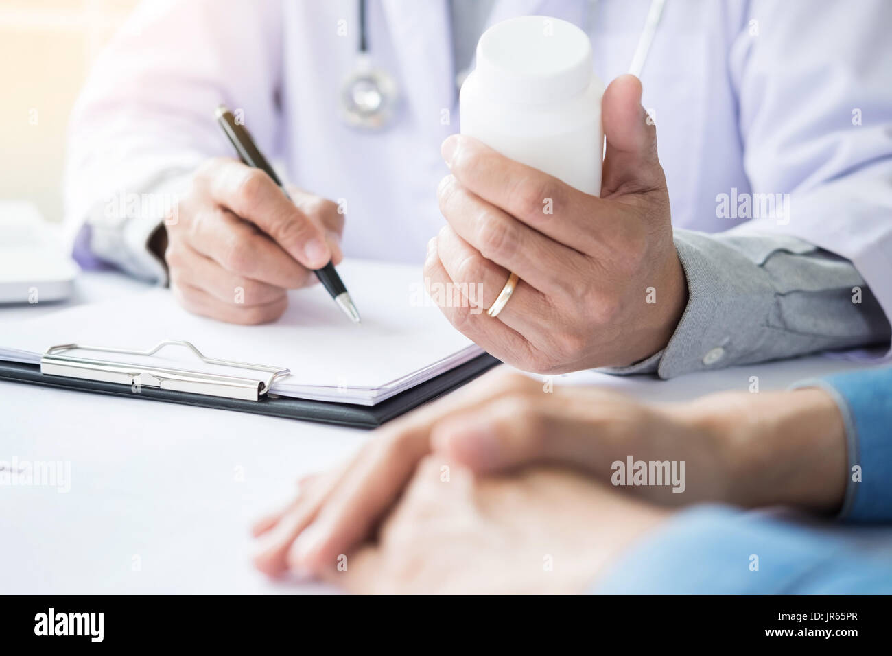 patient listening intently to a male doctor explaining patient symptoms ...