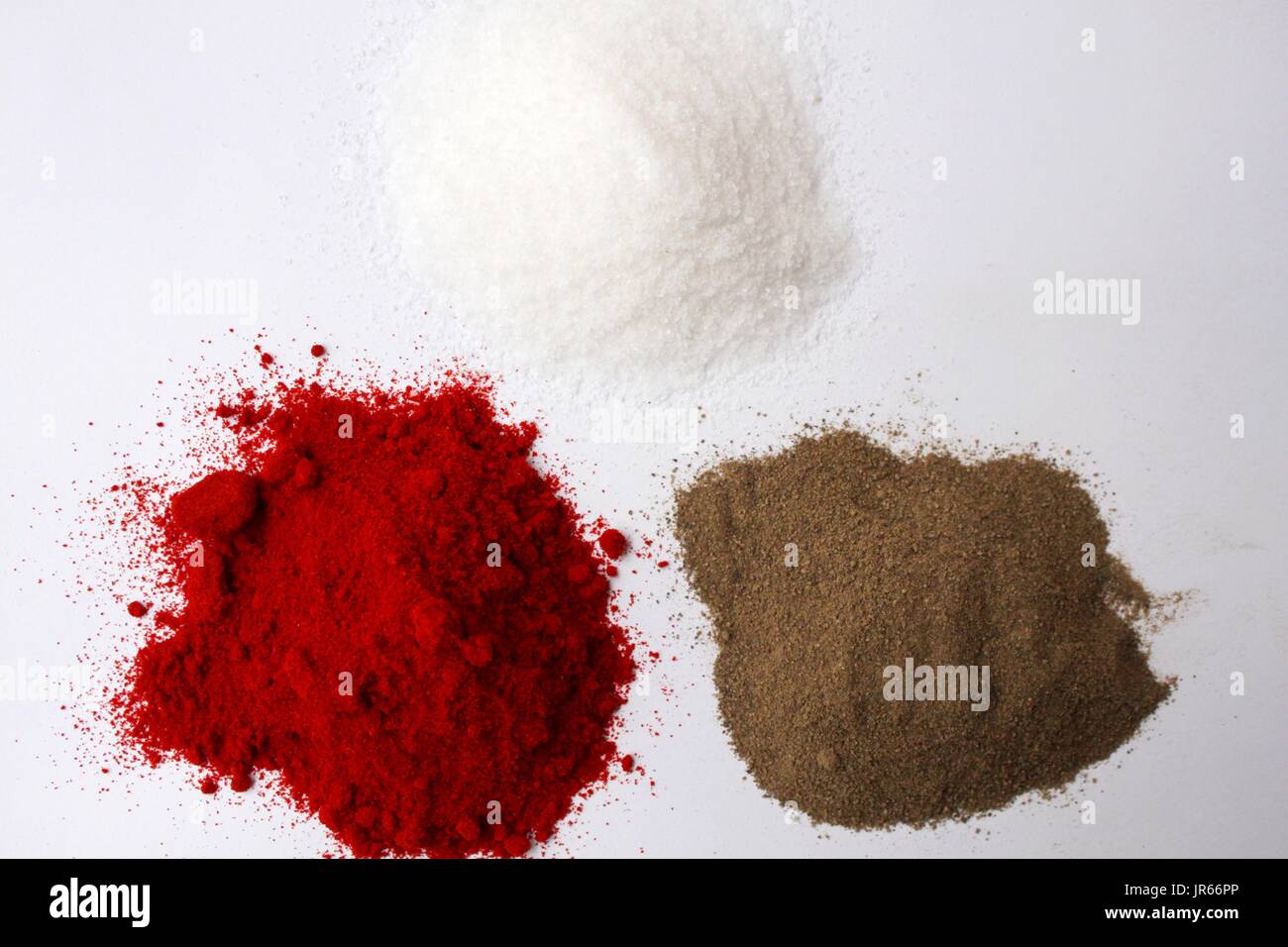 Salt, cayenne pepper and ground black pepper Stock Photo - Alamy