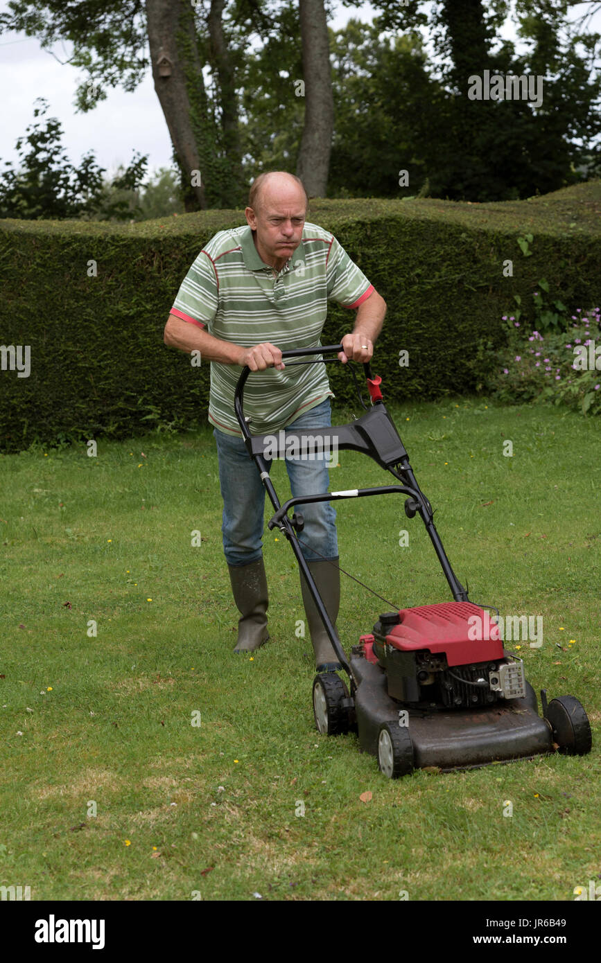 Man pushing mower hi-res stock photography and images - Alamy