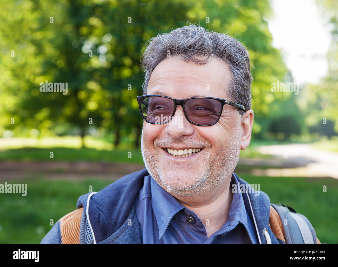 Man smiling standing in park hi-res stock photography and images - Alamy