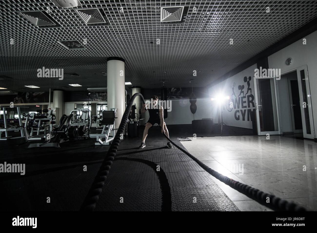Battle ropes exercise in the gym. Crossfit Stock Photo - Alamy