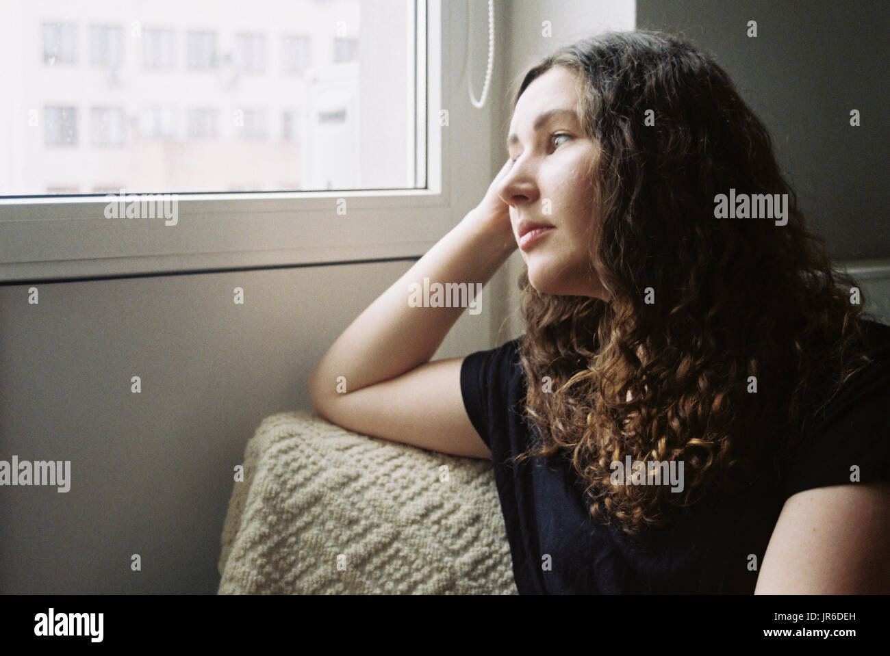 Woman sitting sideways on armchair hi-res stock photography and images ...