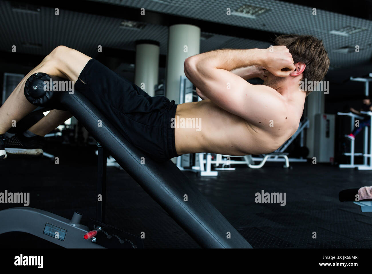 Muscular man exercising doing sit up exercise. Athlete with six pack ...
