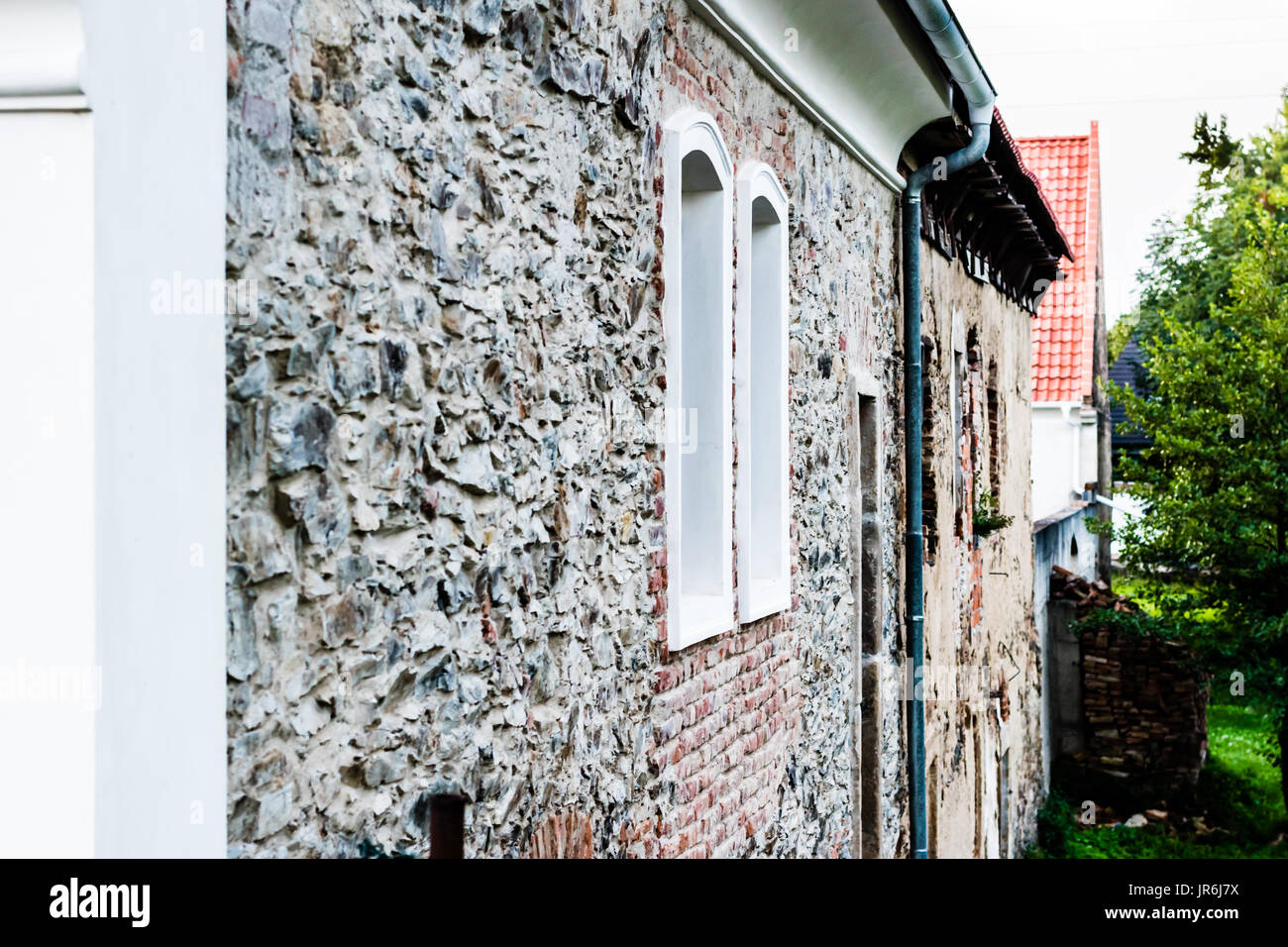 Old generic building with a window and green rural garden Stock Photo ...