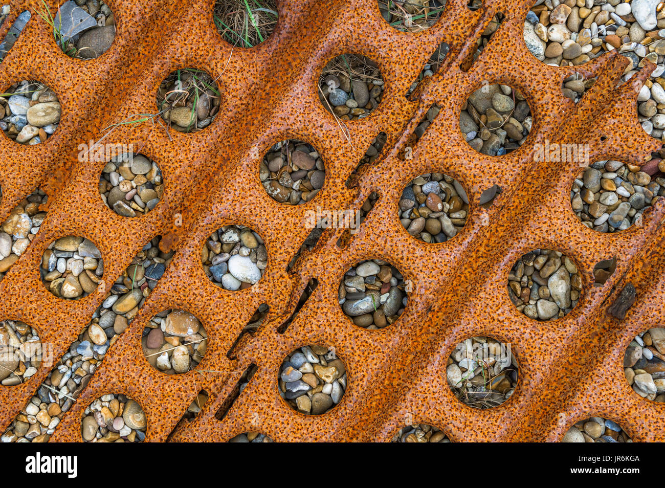 Rusting steel tempory roadway laid on a shingle beach Stock Photo - Alamy
