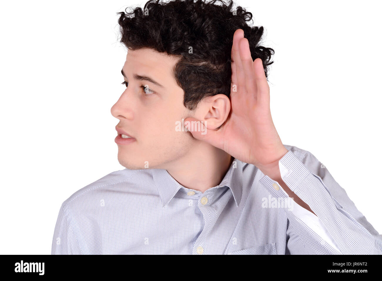 Portrait of attractive young man hearing something. Isolated white ...