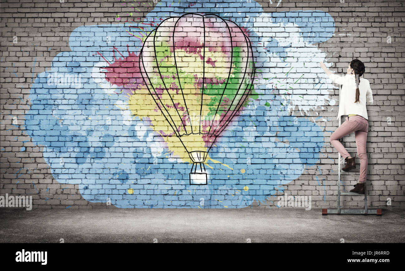 Girl paint wall in colors Stock Photo - Alamy