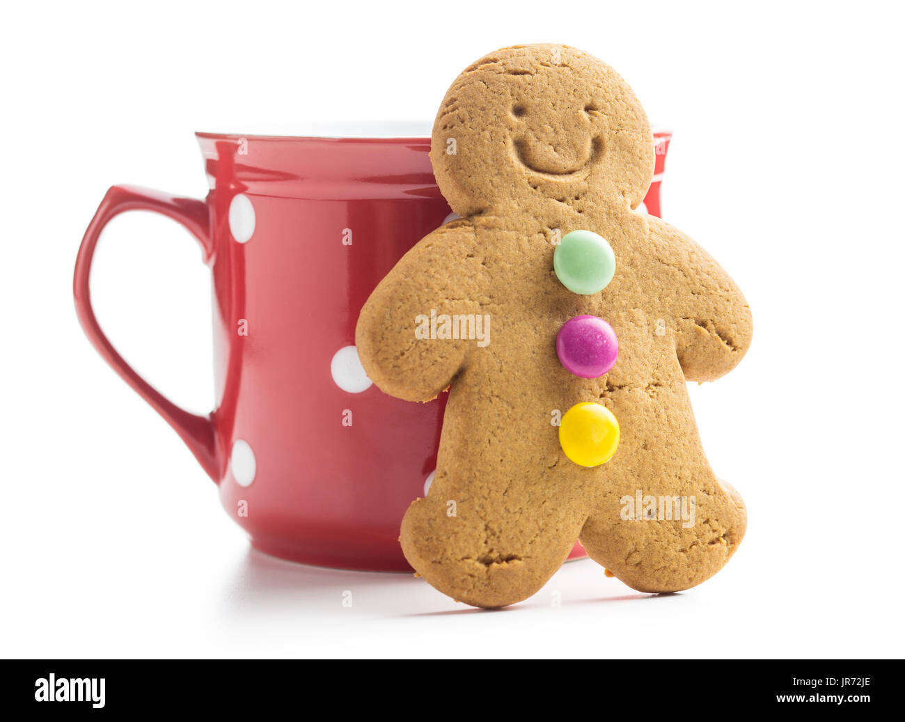 Gingerbread man leaning against a cup isolated on white background ...