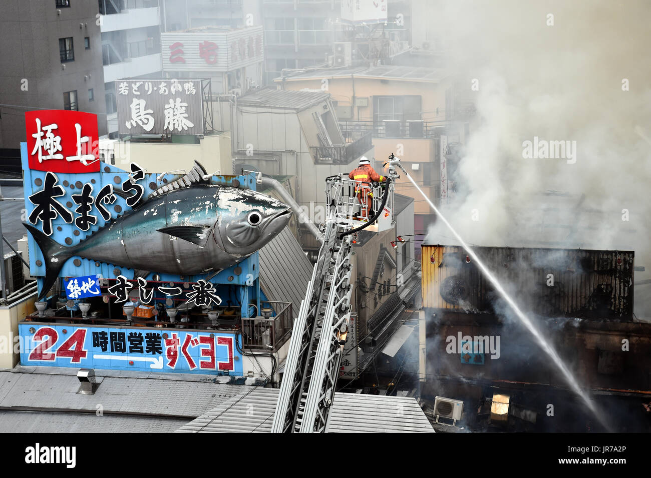 Tokyo, Japan. 3rd Aug, 2017. Firefighters battle a blaze after a fire ...