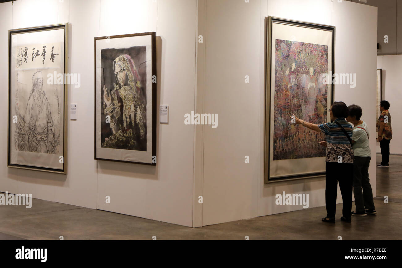 Hong Kong. 3rd Aug, 2017. Visitors view paintings during the Ink Global ...