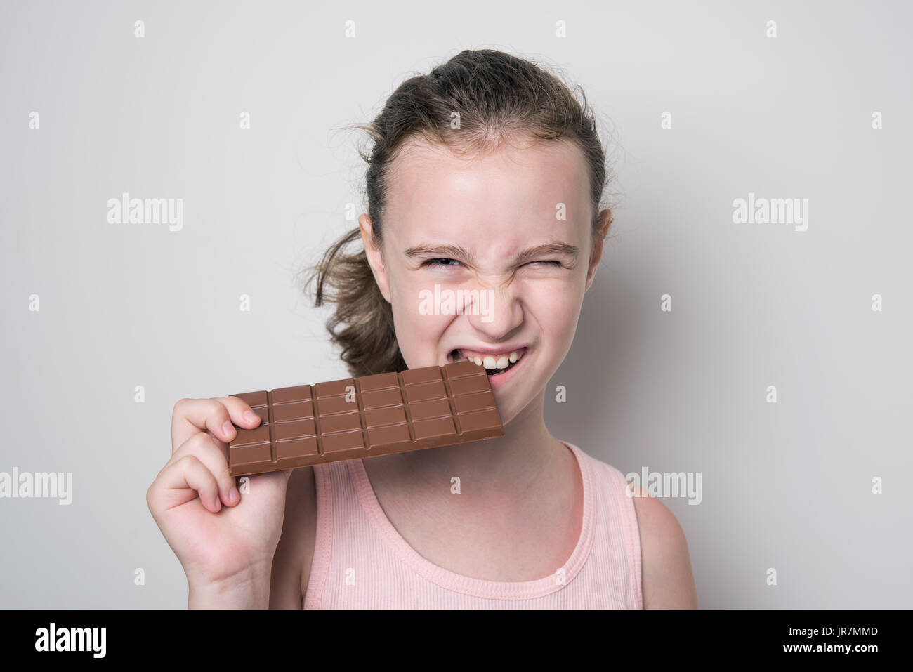 girl biting a chocolate bar Stock Photo - Alamy