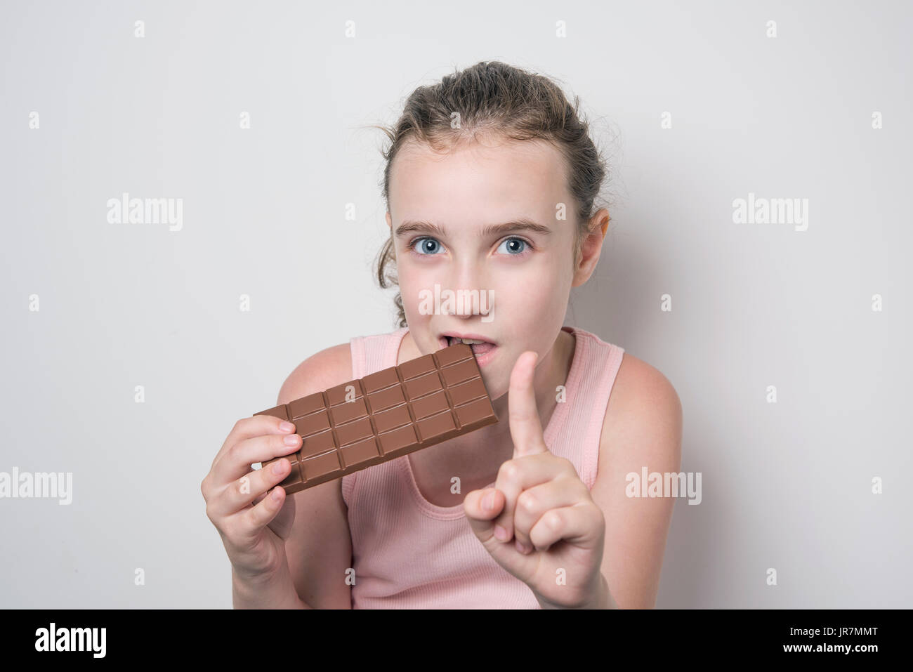 girl biting a chocolate bar Stock Photo - Alamy