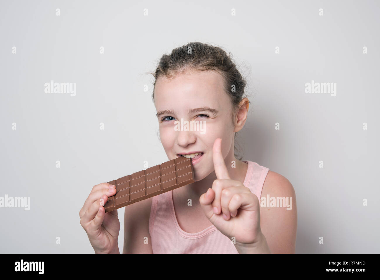 girl biting a chocolate bar Stock Photo - Alamy