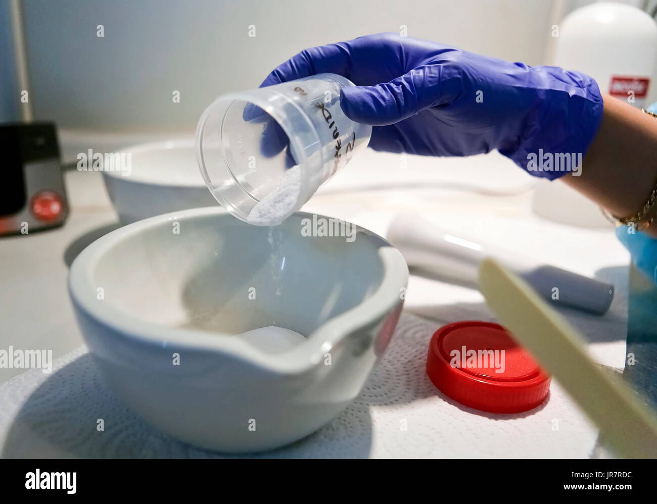 Pharmacist preparing capsules with drugs in her laboratory Stock Photo ...